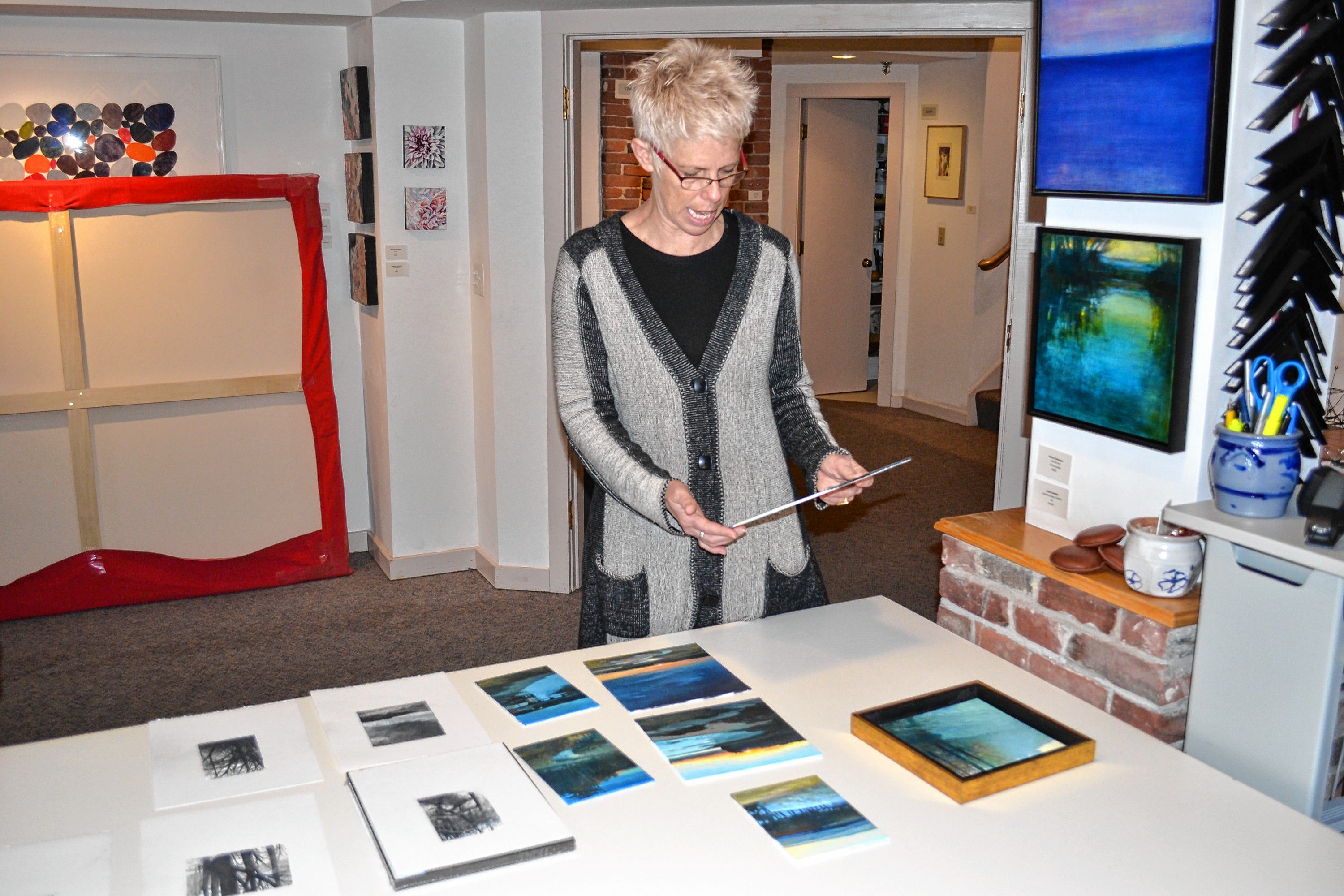 Sarah Chaffee, owner of McGowan Fine Art, talks with one of her many ...