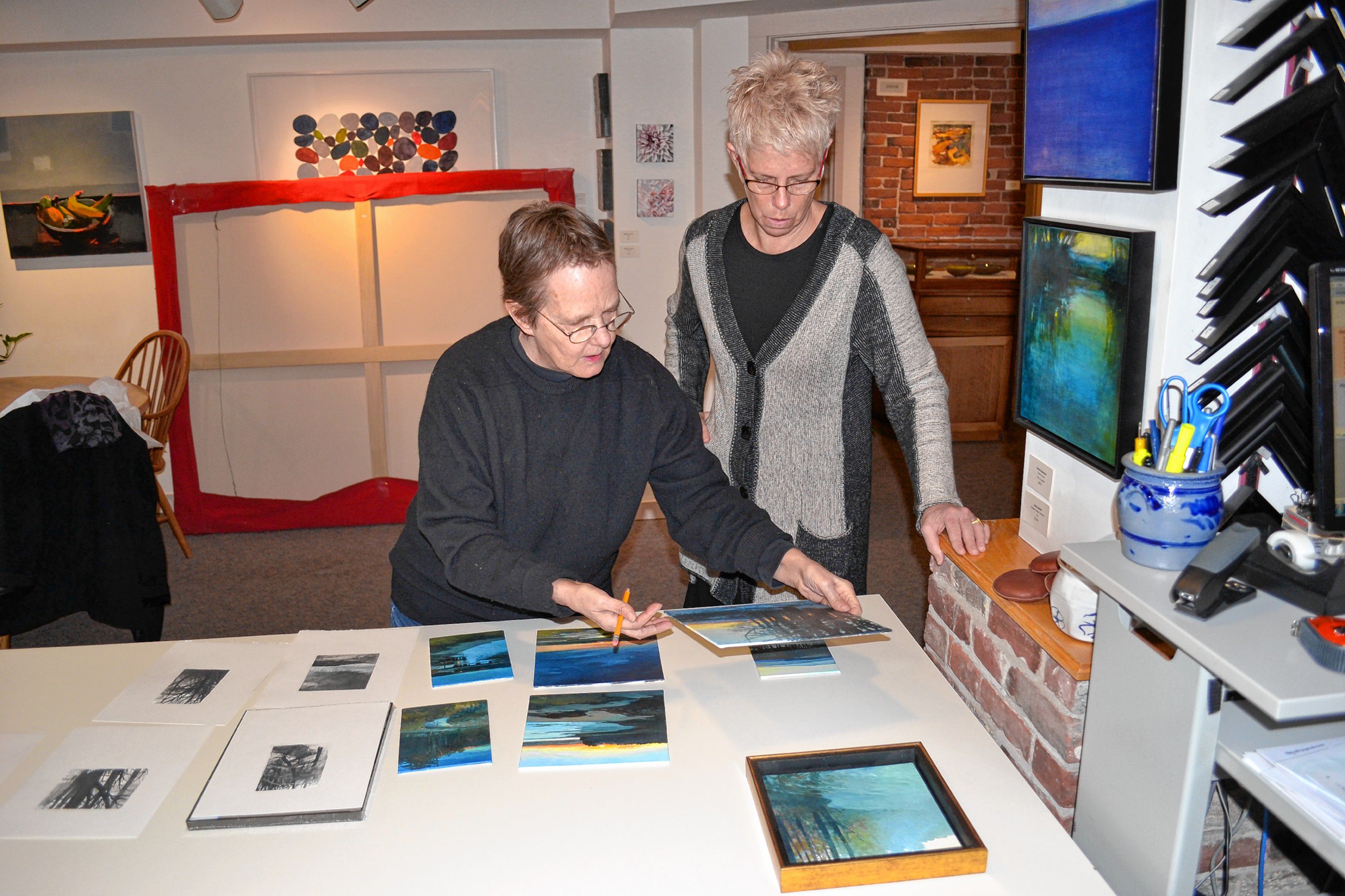 Sarah Chaffee, owner of McGowan Fine Art, talks with one of her many ...