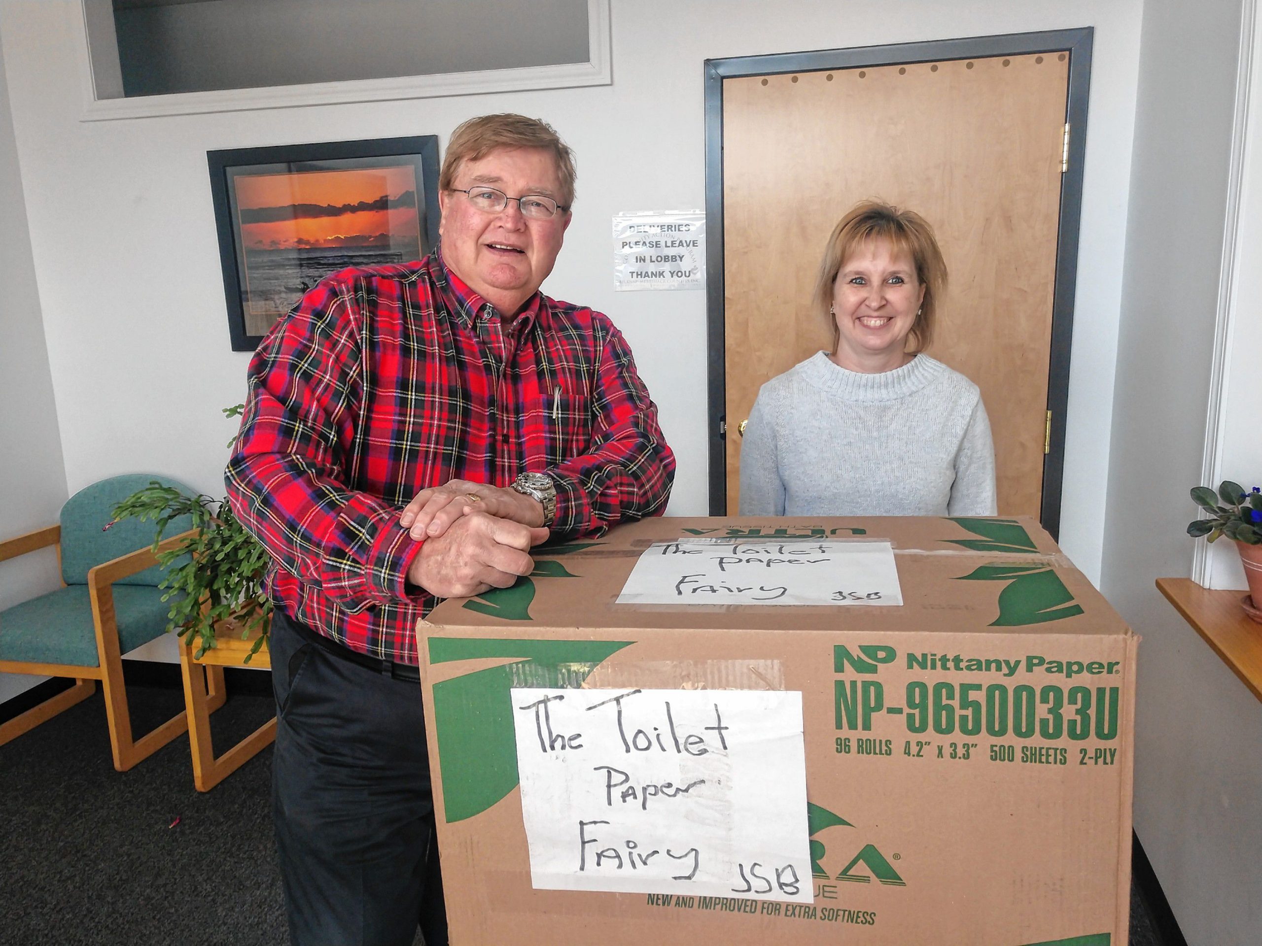 John Ball donates a supply of toilet paper to Michelle Beaudin, the ...